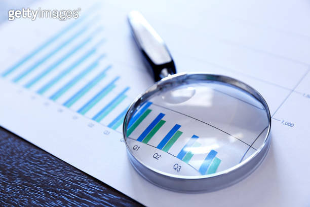 Magnifying Glass On Top Of Bar Chart Showing Decling Performance ...