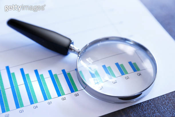 Magnifying Glass On Top Of Bar Chart Showing Decling Performance ...