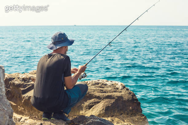 Angler fishing at Aegean sea, Greece 이미지 (1043440810) - 게티이미지뱅크
