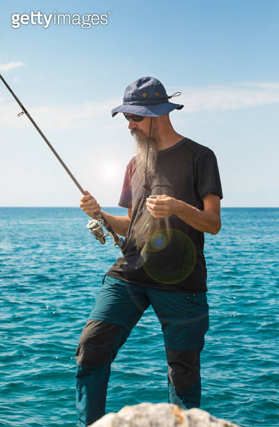 Angler fishing at Aegean sea, Greece 이미지 (1043440898) - 게티이미지뱅크