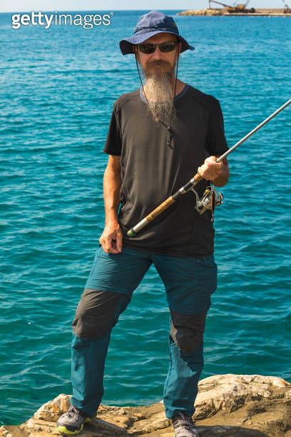 Angler fishing at Aegean sea, Greece 이미지 (1043441066) - 게티이미지뱅크