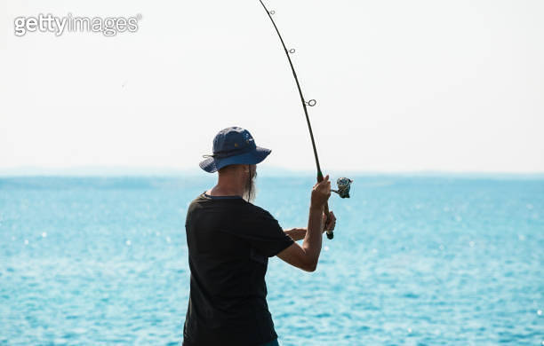 Angler fishing at Aegean sea, Greece 이미지 (1043438280) - 게티이미지뱅크