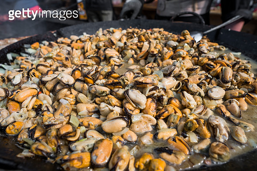 Fresh mussels at grill pan. Seafood barbecue outdoors. Picnic healthy ...