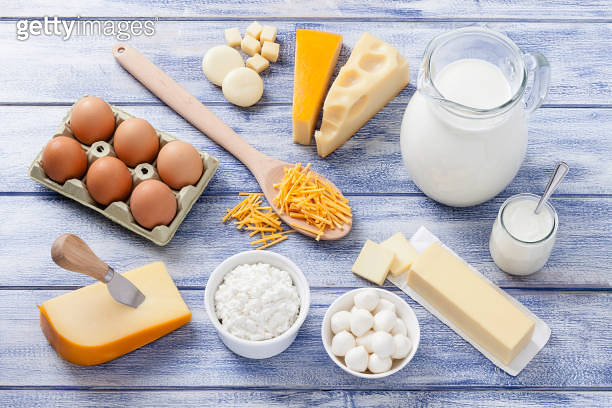 Most common dairy products shot from above on blue striped table 이미지 ...