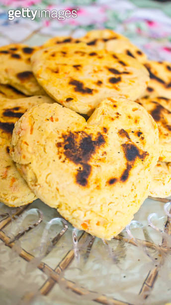 Maize flour bread called arepa typical of Venezuela in the form of a ...