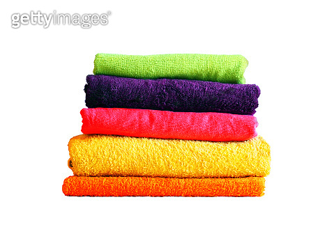 Large stack of terry towels of different colors isolated on white ...