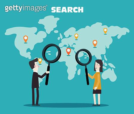 Businessman and businesswoman holding magnifying glass over world map ...
