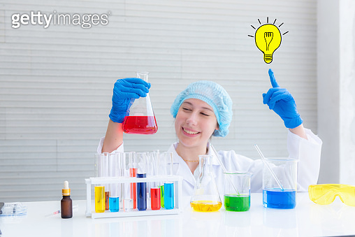 Portrait of beautiful woman laboratory scientist thinking idea about ...