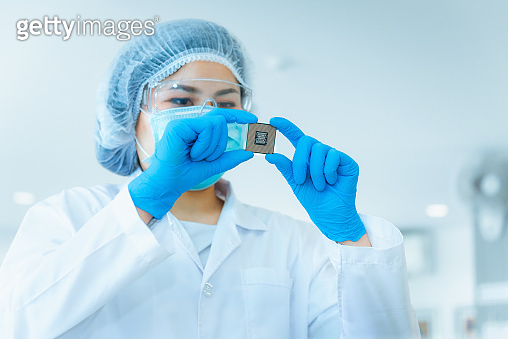 Portrait of electronics engineer is holding CPU's computer for ...