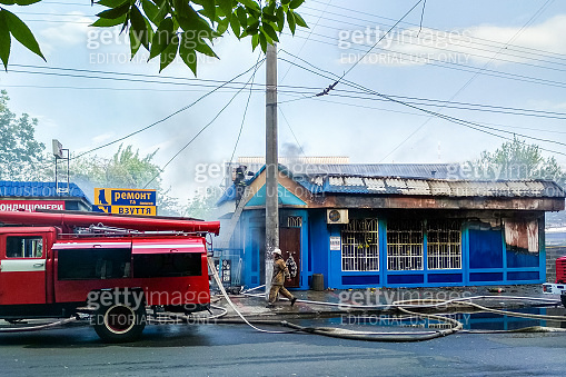 The burning of a shop on the city street. Extinguishing the fire ...