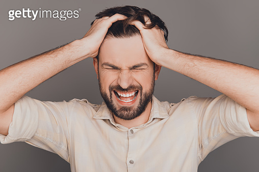Frustrated angry man with big problems yelling and touching head ...