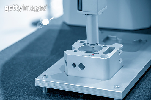 The multi-axis CMM machine measure the aluminum automotive part ...
