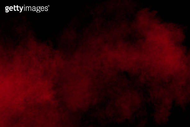 abstract red dust explosion on black background.Freeze motion of red ...