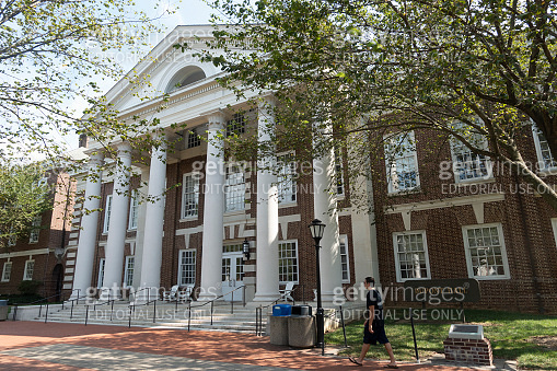 A male student walking past Dupont Hall in the campus of University of ...