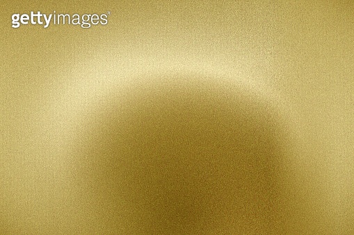 Light shining on brushed gold metal panel, abstract texture background ...