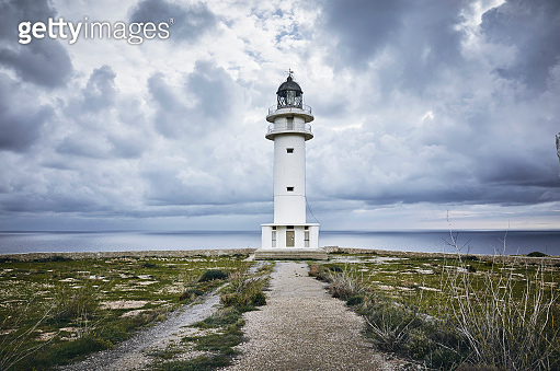 Barbaria Lighthouse in formentera Islan in spain with a cloudy sky ...