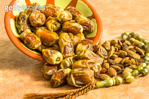 lots of fresh and healthy dates kept in a muddy Arabian traditional pot ...