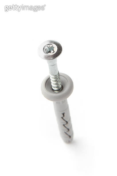 Steel screw and plastic anchor for fixture in concrete wall isolated on ...
