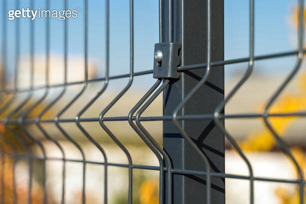 Steel grating fence made with wire on blue sky background. Sectional ...