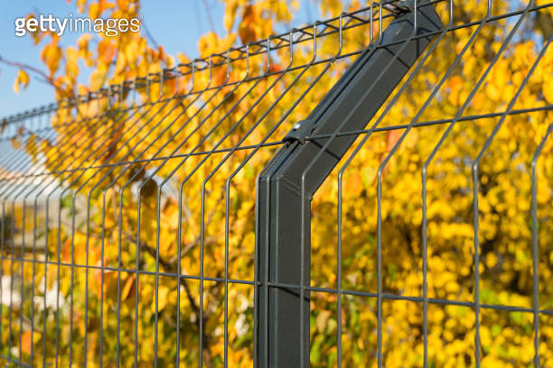Steel grating fence made with wire on blue sky background. Sectional ...