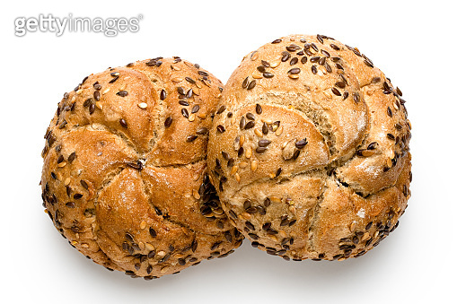 Two traditional whole wheat kaiser rolls with linseeds and sesame seeds ...