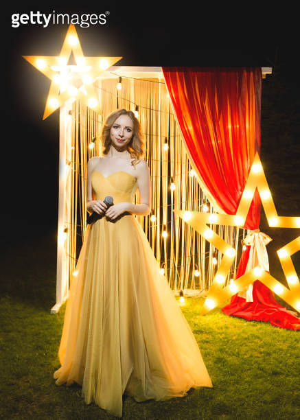 Presenter woman in dress with microphone. Emcee definition is - master ...