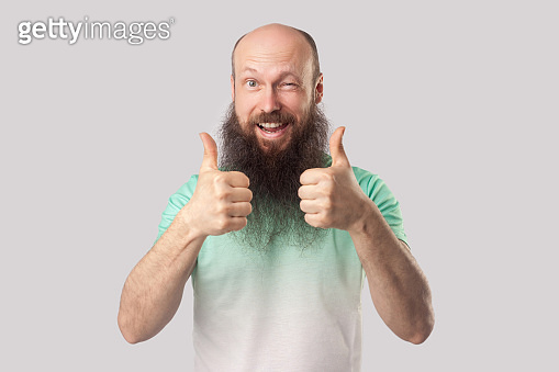Portrait of glad satisfied middle aged bald man with long beard in ...