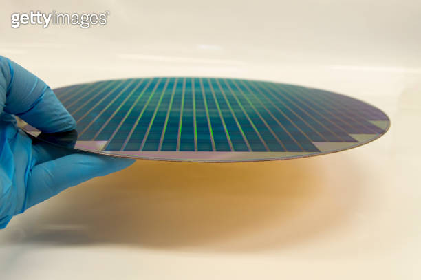Gloved Hand Holding a Patterned 12 Inch 300 mm Silicon Wafer Against a ...