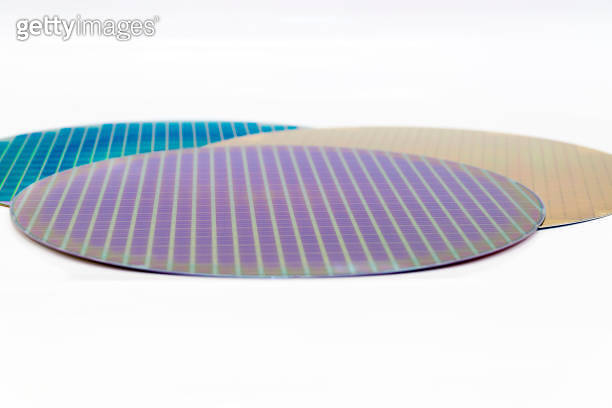 Three Multicolored Patterned 12 Inch 300 mm Silicon Wafers On a White ...