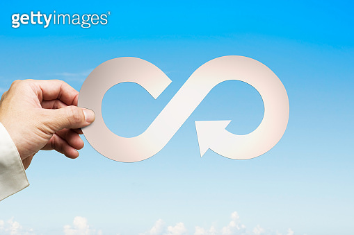 Hand holding arrow infinity recycling symbol, circular economy concept ...