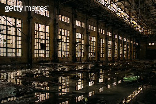 Dark dirty flooded dirty abandoned ruined industrial building with ...