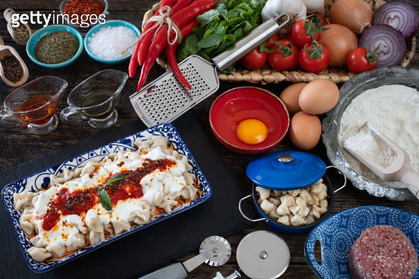 Turkish ravioli manti preparation with meat, yogurt, butter and dough ...