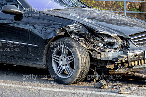 Car accident closeup with a broken partial car and some messy liquids ...