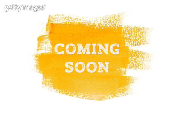 Coming soon on yellow paint background, isolated on white. Advertising ...