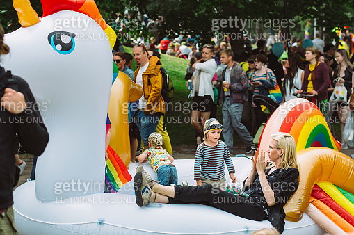 Kids having fun on inflatable unicorn on Helsinki Pride festival in ...