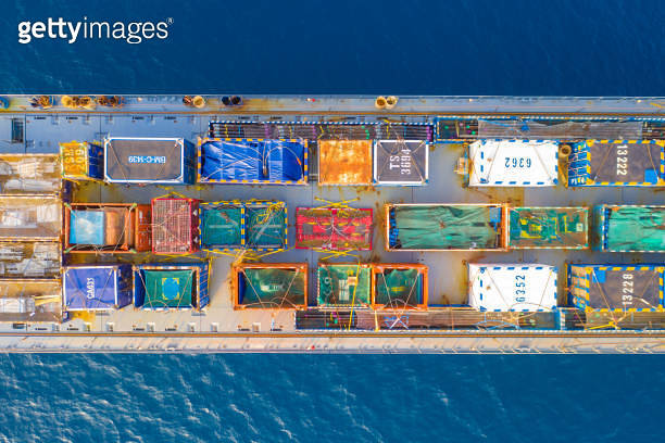 Cargo Ship loaded with colourful Containers and large crates cruising ...