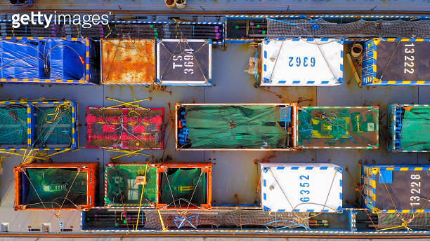 Cargo Ship loaded with colourful Containers and large crates cruising ...