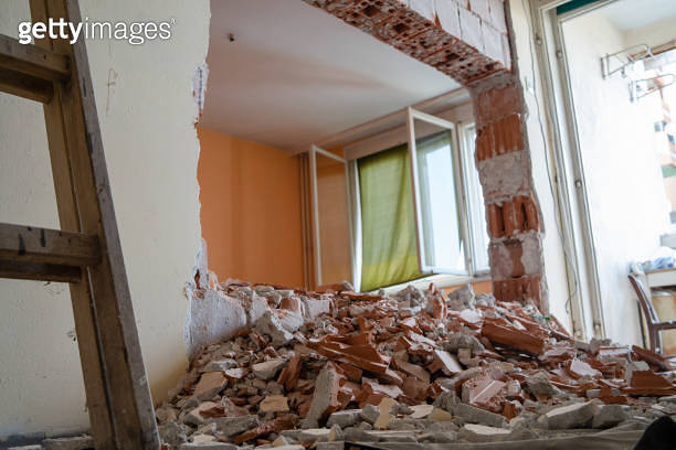 Wall smashed into debris room in apartment ready for renovation with ...