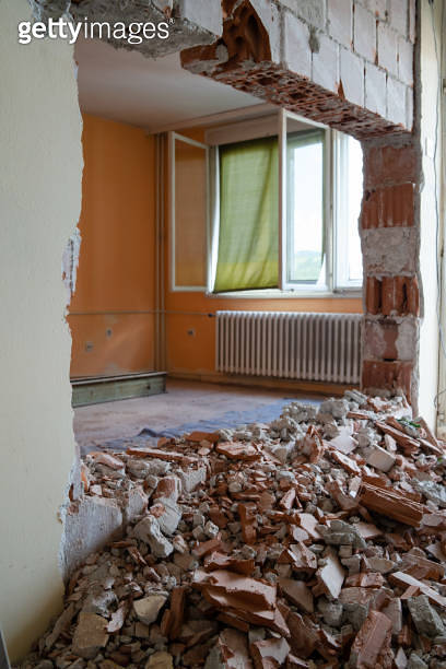 Wall smashed into debris room in apartment ready for renovation with ...