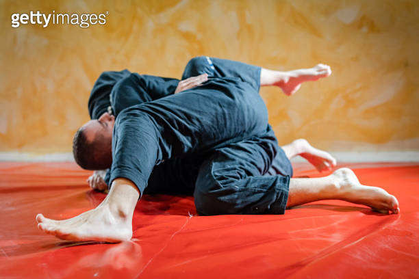 Two brazilian jiu jitsu athletes working on BJJ side control position ...