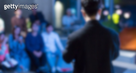 Blurred business presentation being given by young executive. Corporate ...