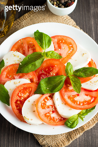 Close-up photo of caprese salad with ripe tomatoes, basil, buffalo ...