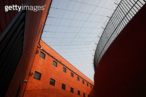 Brick jail building with prison fence with barbed wire (1092229470 ...