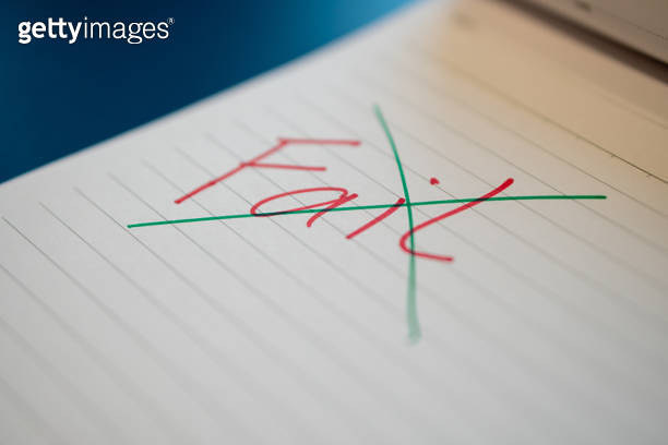 Fail text with a hand with a red pen And crossed out with a green pen ...