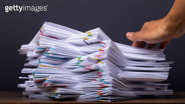 Man hand pick up Stack overload document report paper with colorful ...
