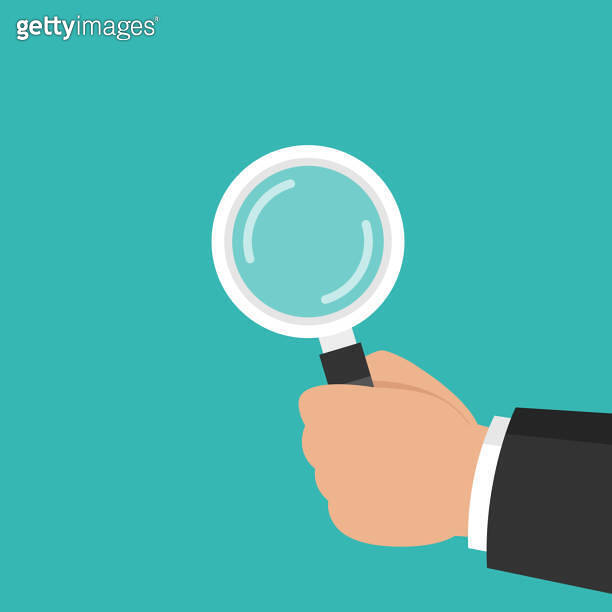 Hand holding a magnifying glass. Audit, analysis, inspection concepts ...