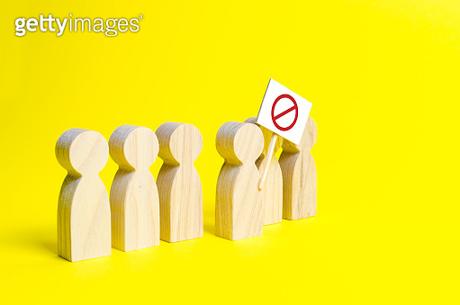 The person's figure comes out of the line with a sign on an yellow ...