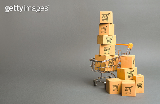 Shopping cart and boxes with drawing of smaller carts. goods sale ...