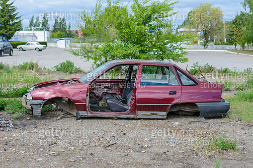Broken, crumpled, dented car after the accident. Abandoned wrecked cars ...