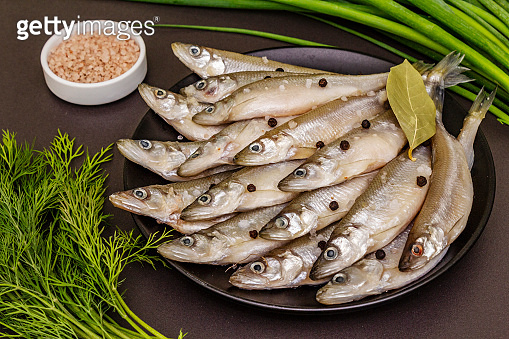 Raw sea fish smelt, sardines, anchovies, capelin with the scent of ...